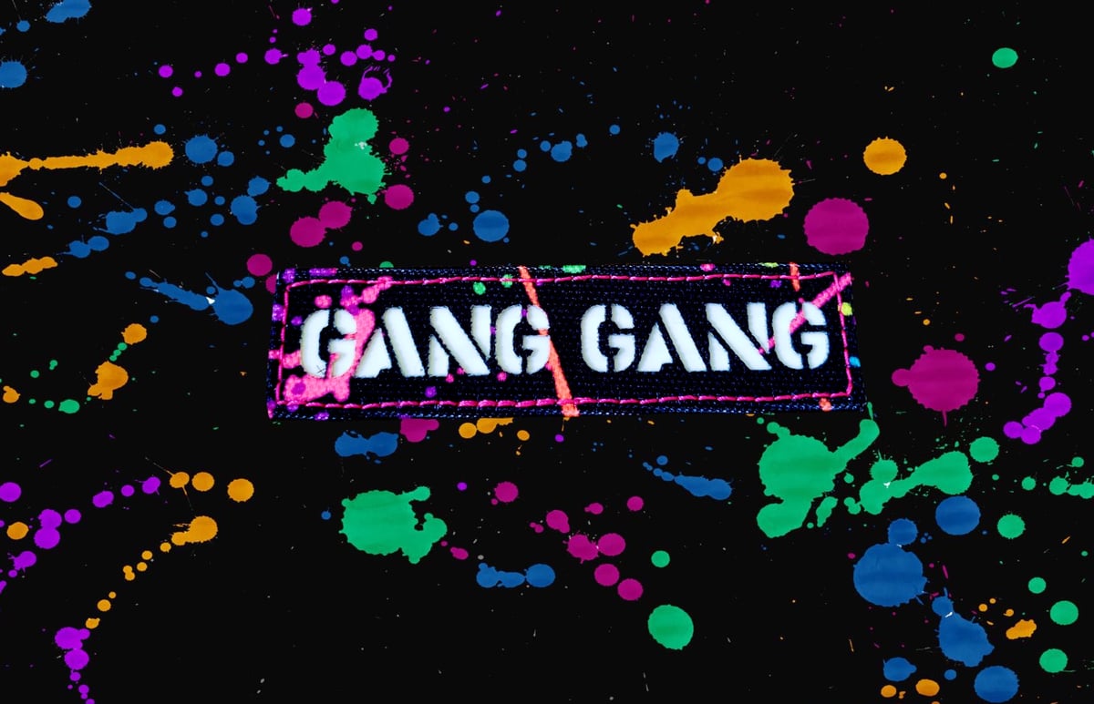 "Gang Gang" splatter paint laser cut glow-in-the-dark | Golden Tiger Workz