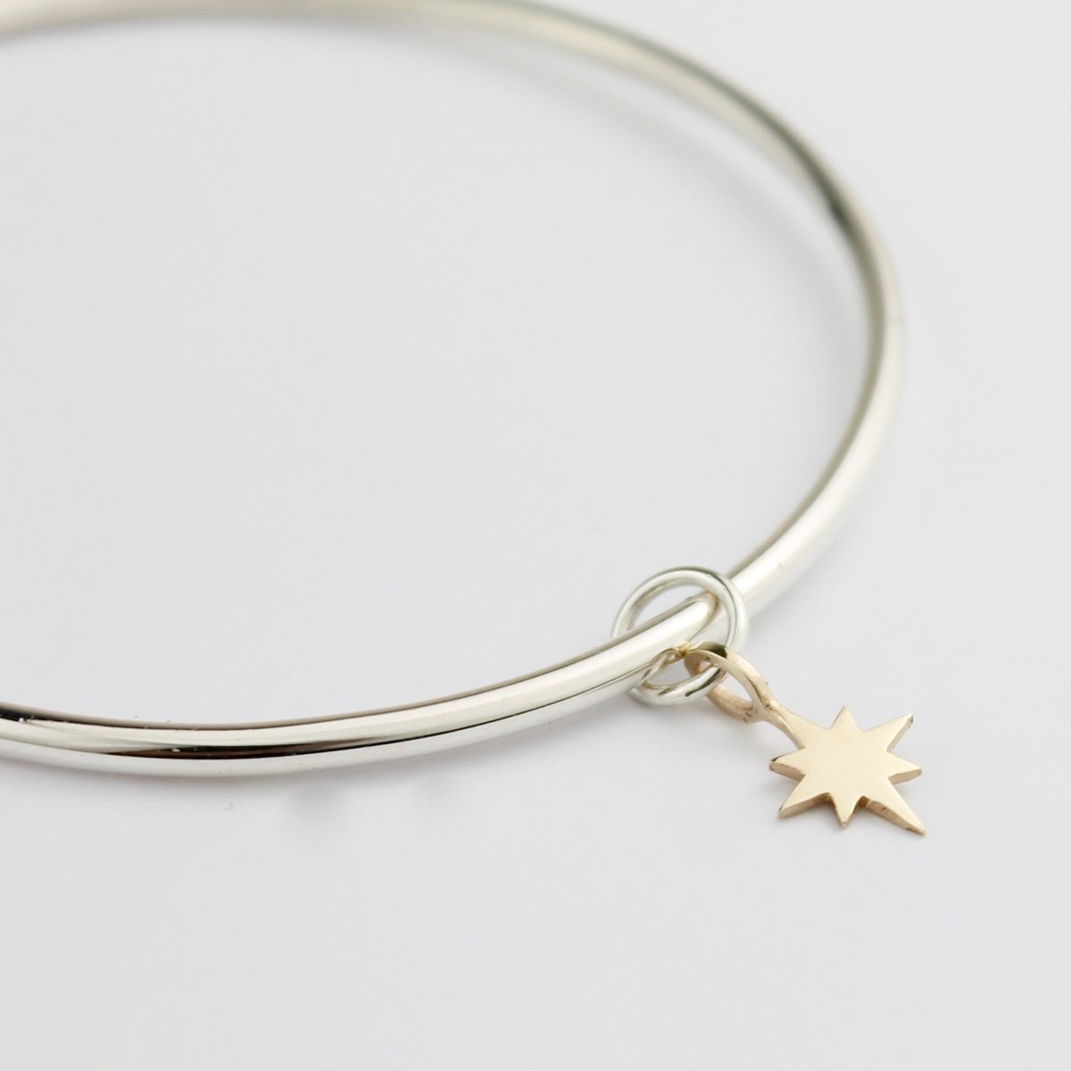 Handmade silver bangle with 9ct yellow gold eight pointed star ...
