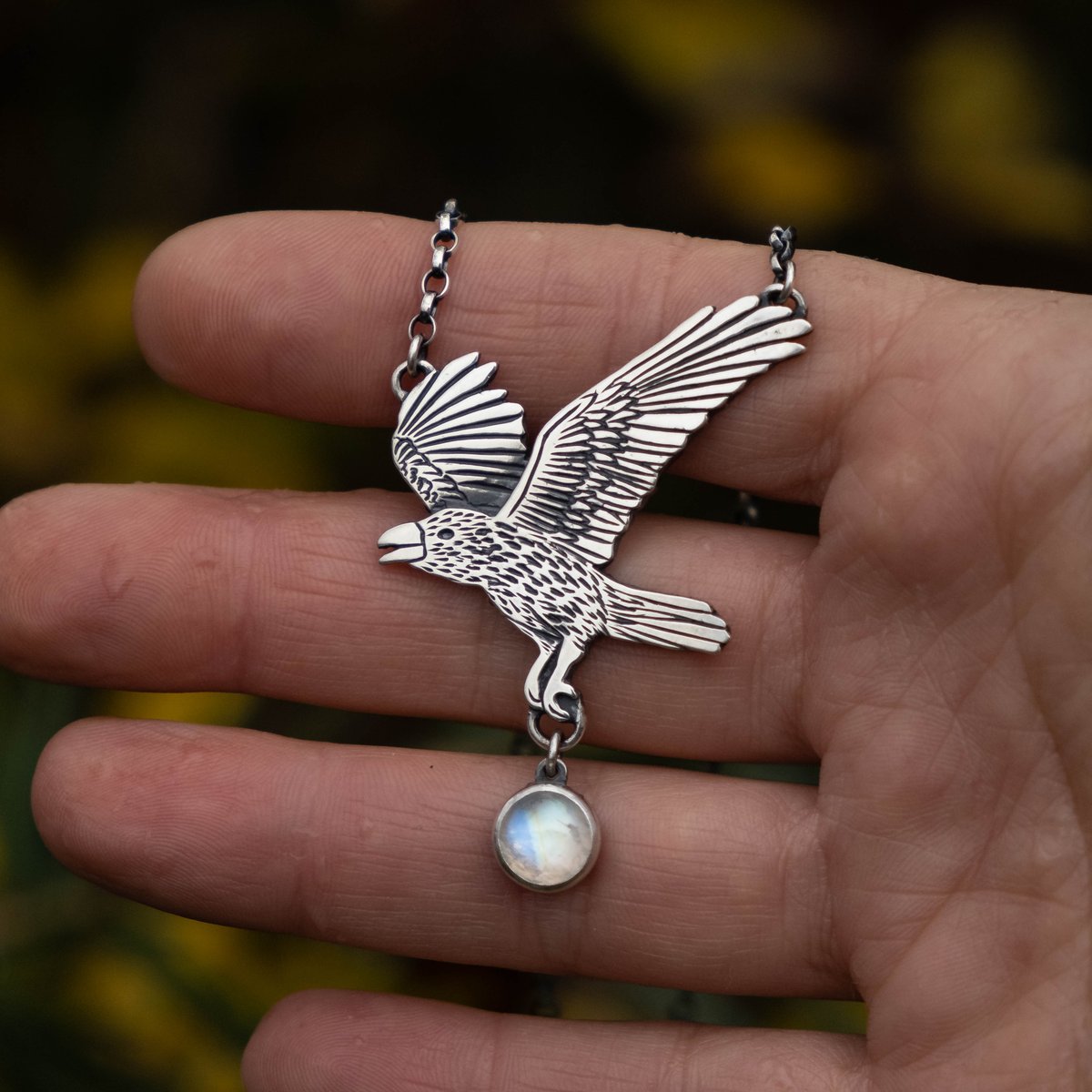 Flying raven carrying a moon 1 | Kokopeli Studio